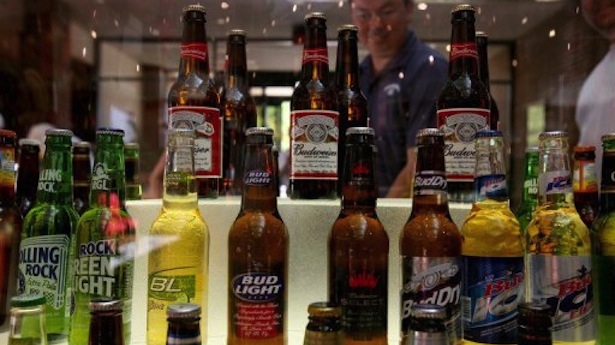 Visitors-look-over-a-display-case-of-beers-made-by-the-Anheuser-Busch ...